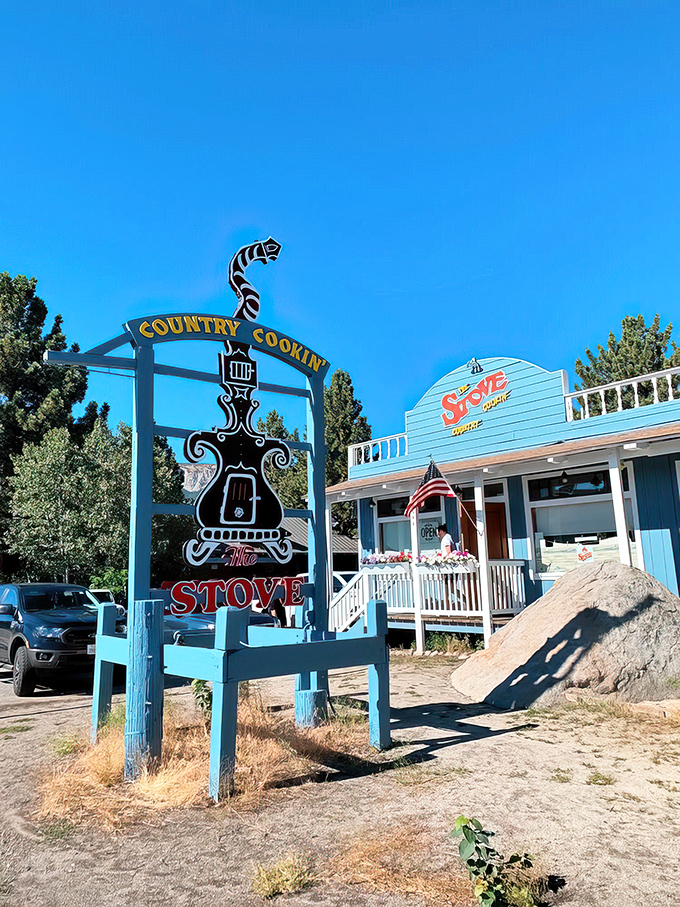 The iconic blue exterior of The Stove with its vintage sign promising "Country Cookin'" stands like a beacon for breakfast pilgrims in Mammoth Lakes.