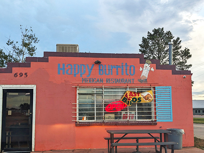 The pink adobe exterior of Happy Burrito stands out like a desert mirage, complete with vintage Studebaker that's as classic as their recipes.