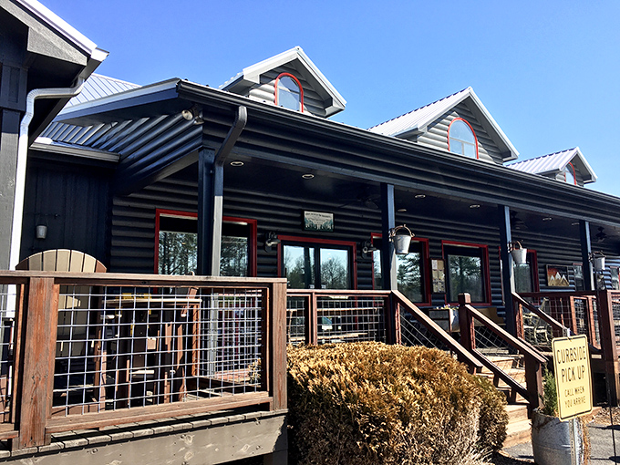 The log cabin exterior of The Sawmill Place stands proudly against blue Georgia skies, promising comfort food that'll make your soul do a happy dance.