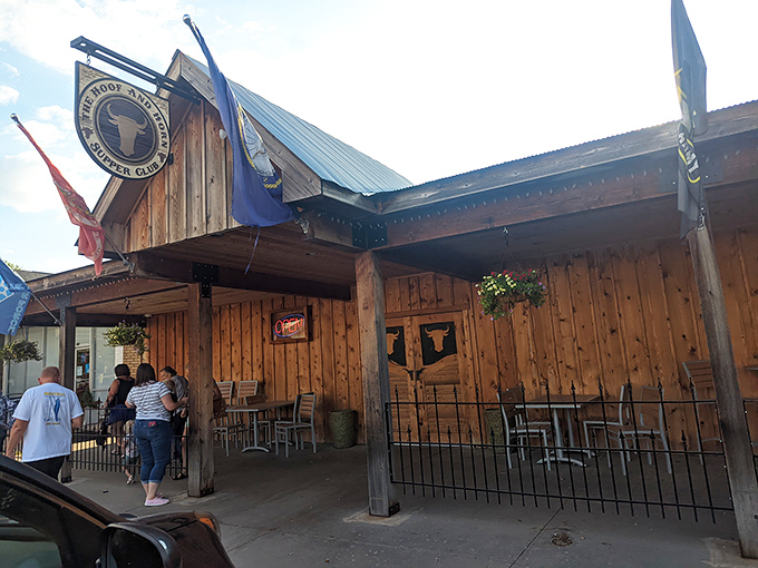 The Hoof & Horn's wooden facade glows with string lights against the Kansas night sky, like a beacon for hungry travelers.