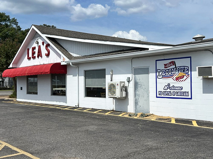 The iconic white building with bold red "LEA'S" lettering and matching awning stands as a beacon for hungry travelers &ndash; a Louisiana landmark since 1928.