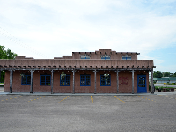 Where New Mexico meets Nebraska: Gringo's adobe-style exterior with its distinctive vigas and bright blue doors is your first hint that culinary adventure awaits inside.