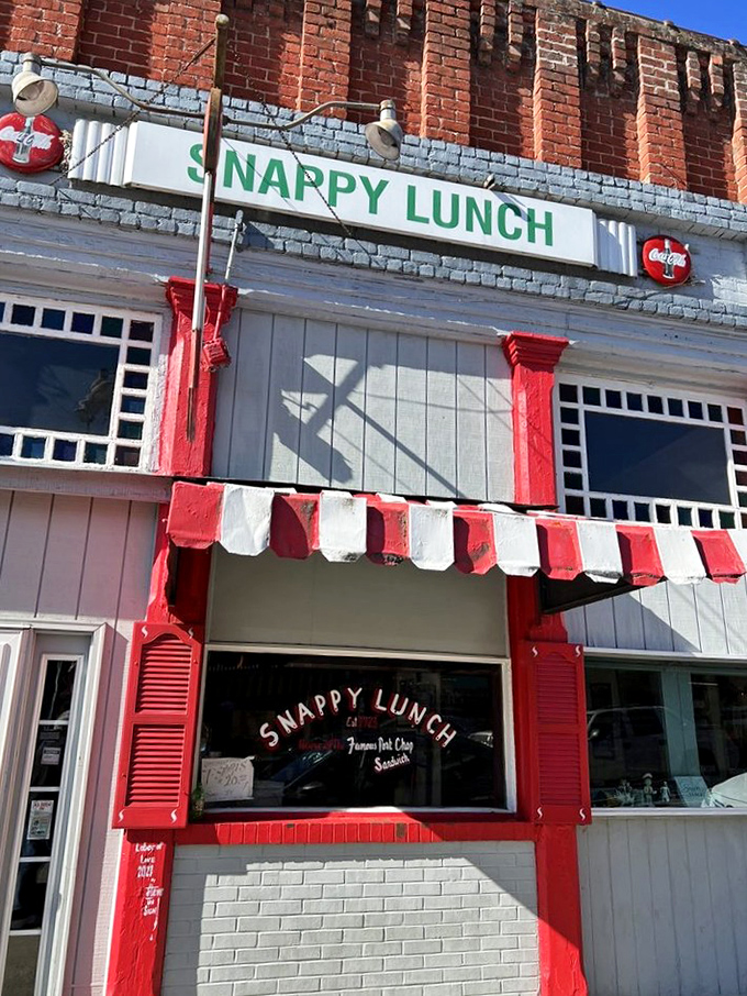 The time-traveling storefront of Snappy Lunch beckons with its cheerful red and blue facade, a nostalgic beacon on Mt. Airy's Main Street since 1923.