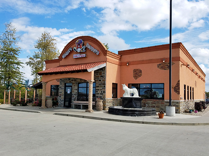 Stone archways and vibrant orange walls create the perfect backdrop for what's about to become your new favorite Mexican escape in Ohio.