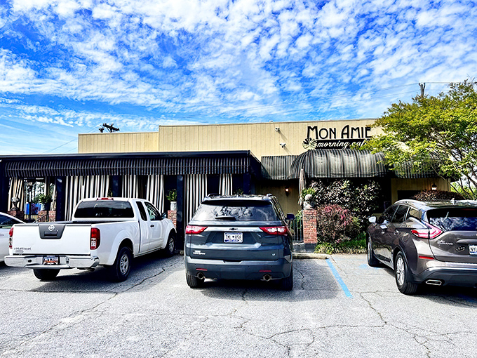 The sunshine-yellow exterior of Mon Amie isn't just a building&mdash;it's a morning promise waiting to be kept. French charm meets Southern hospitality behind those striped awnings.