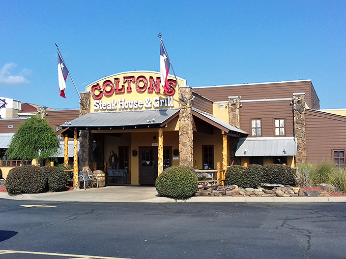The rustic stone facade of Colton's stands like a carnivore's lighthouse, beckoning hungry travelers with promises of perfectly grilled protein.