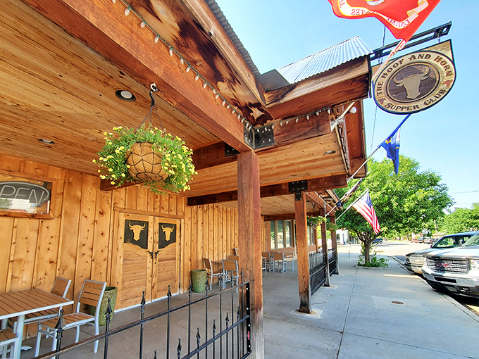 The Hoof & Horn's wooden facade glows with string lights against the Kansas night sky, like a beacon for hungry travelers.