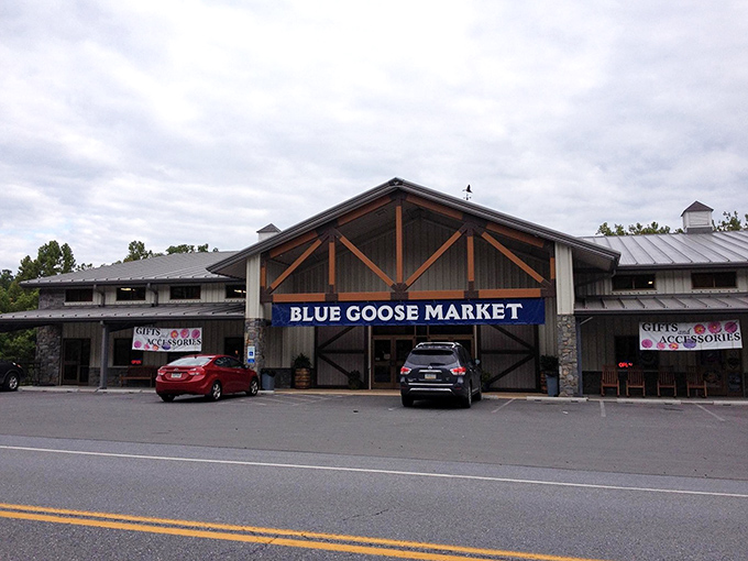 The rustic timber-framed exterior of Blue Goose Market beckons like an oasis for hungry travelers on Maryland's historic National Road.