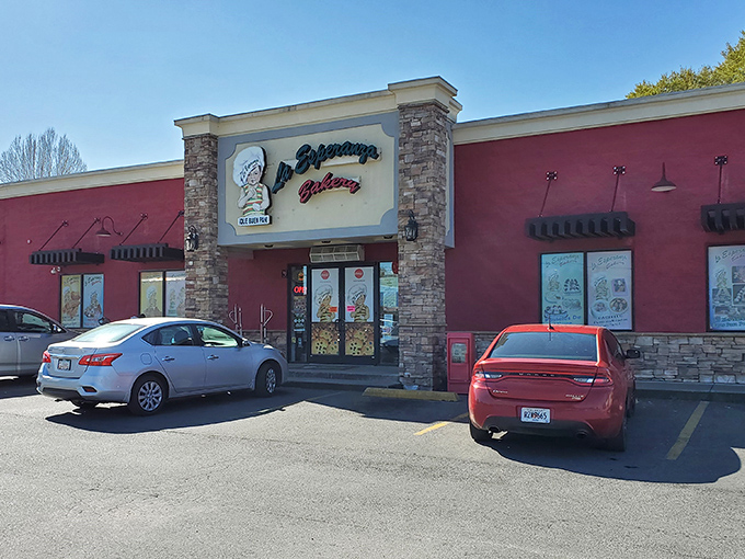 The vibrant pink exterior of La Esperanza Bakery stands out like a delicious dessert itself, beckoning hungry travelers with promises of authentic Mexican treats.