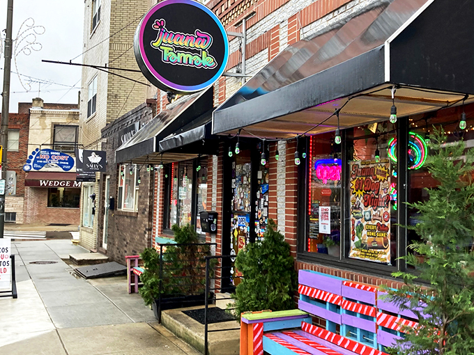 The colorful storefront of Juana Tamale beckons like a fiesta waiting to happen. Mexican flags and vibrant signage promise authentic flavors on East Passyunk Avenue. 