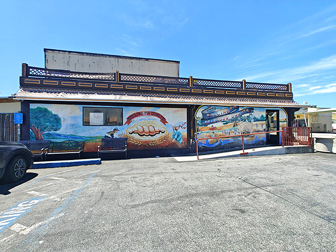 The storybook exterior of Rolling Pin Donuts stands like a beacon of sweetness on San Bruno's El Camino Real, promising delicious treasures within.