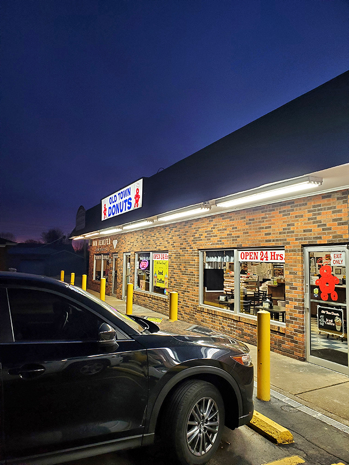 The iconic yellow hand holding a pink donut says it all – resistance is futile at this 24-hour temple of fried dough.