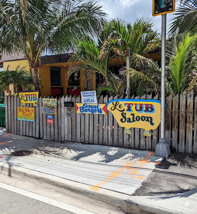 The unassuming entrance to burger paradise. Like finding a pirate's treasure map disguised as a fence, Le Tub's weathered exterior hides culinary gold within.