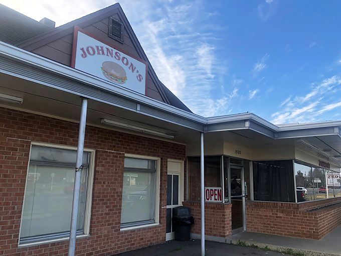 The unassuming brick exterior of Johnson's Drive-In has welcomed burger pilgrims since 1946, proving that greatness rarely needs fancy packaging.