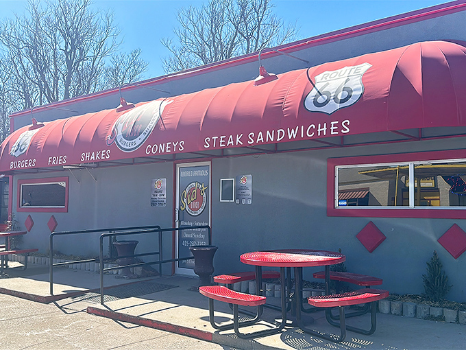 The modest exterior with its vibrant red awning and Route 66 shield promises more than meets the eye&mdash;culinary magic happens inside these unassuming walls.