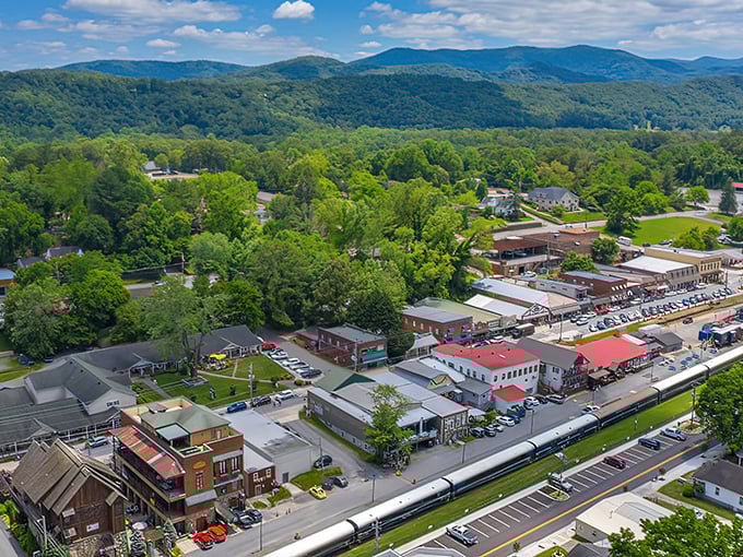 Blue Ridge unfolds like a storybook mountain town from above, its charming streets nestled among endless rolling green hills that seem to stretch into forever.