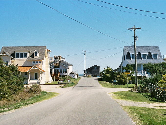 Ocracoke's main street at dusk feels like stepping into a storybook &ndash; where every shop has a tale and string lights guide your way home.
