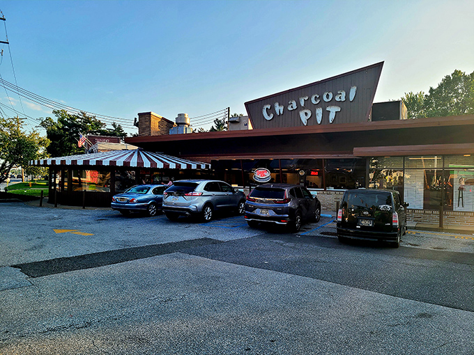 The mid-century charm of Charcoal Pit stands proudly on Concord Pike, its distinctive angular roof beckoning burger lovers like a meaty lighthouse on Delaware's culinary shore.