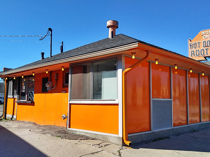 Like a sunset captured in architecture, Monroe's vibrant orange exterior promises something special inside. No fancy frills, just hot dog perfection waiting to happen.