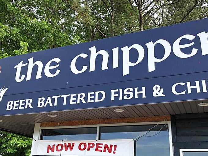 The blue facade of The Chipper stands like a beacon of British comfort food amid Virginia greenery, promising authentic fish and chips to weary travelers.