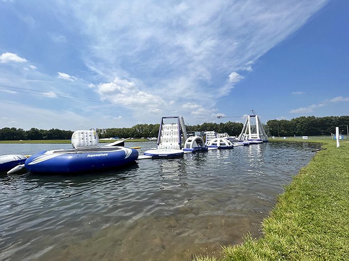 Blue and white inflatable obstacles dot the lake like a playground designed by someone who really understands the joy of controlled chaos.