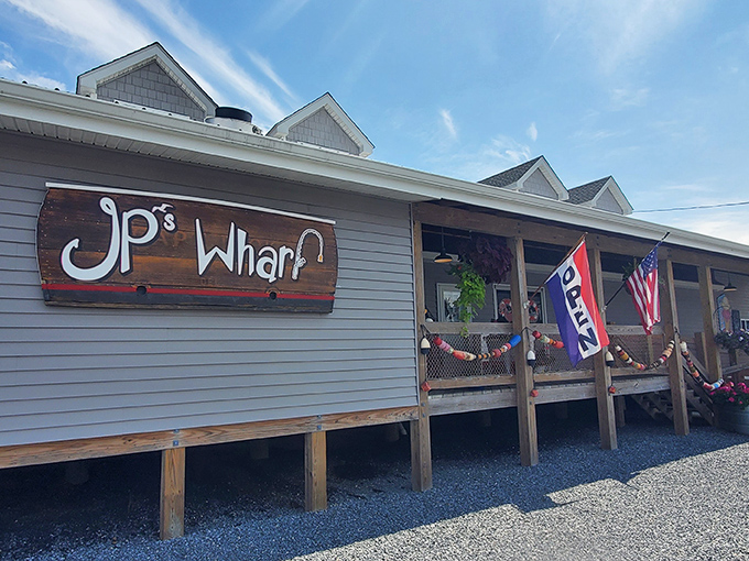 The quintessential coastal dining experience awaits at JP's on the Wharf, where weathered wood decking and blue umbrellas set the stage for waterfront magic.