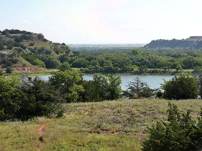 Mother Nature's masterpiece unfolds at Lake Watonga, where Oklahoma's blue skies reflect perfectly in waters that have quenched thirsts for centuries.