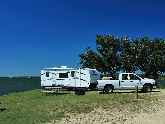 Tranquility has an address, and it's right here where water meets sky. A lone angler finds solitude while someone savors the view from shore.