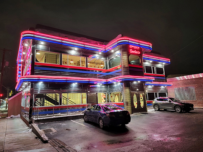 The neon-lit exterior of Goobers Diner glows like a beacon of nostalgia against the night sky, promising comfort food and a trip back in time.