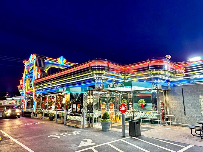 The neon-drenched facade of Marietta Diner glows like a beacon for hungry souls, a chrome-clad time machine promising comfort food and nostalgia.