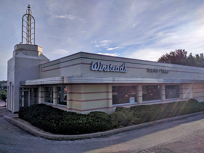 The iconic Art Deco exterior of Winstead's stands as a time capsule of mid-century design, complete with that unmistakable spire reaching skyward.