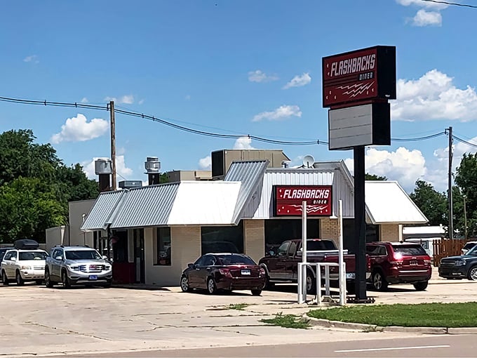 That iconic red sign against the Kansas sky promises more than just a meal—it's a ticket to simpler times when drive-ins ruled the roadside.