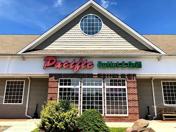 The red and green neon sign of Pacific Buffet & Grill beckons like a lighthouse for the hungry traveler navigating suburban Connecticut.