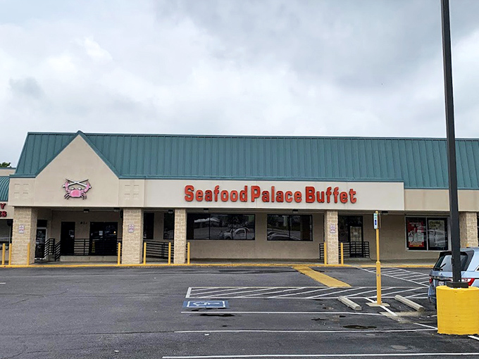 The unassuming exterior of Seafood Palace Buffet stands like a seafood speakeasy, its little crab logo promising treasures that belie its strip mall location.