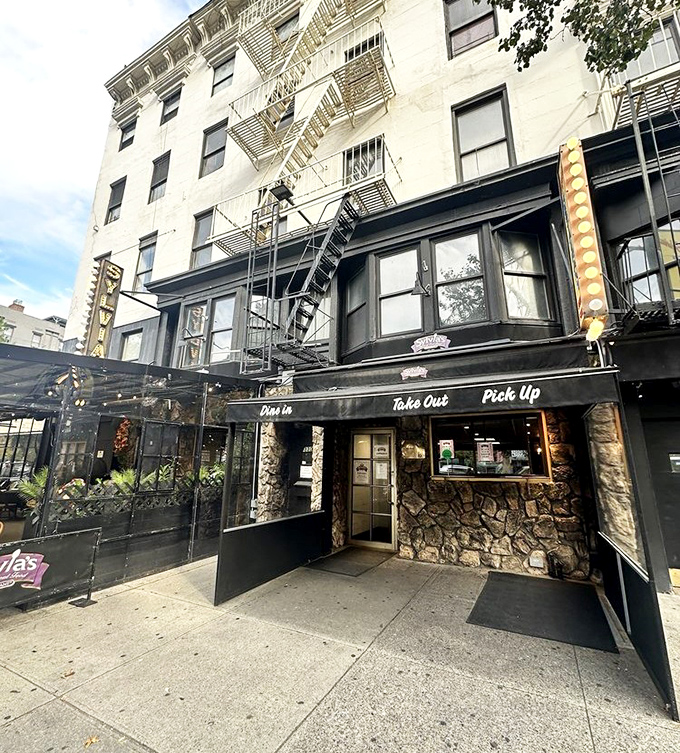 The classic New York storefront beckons with its iconic yellow sign &ndash; Sylvia's standing proud on Malcolm X Boulevard like a culinary lighthouse in Harlem.