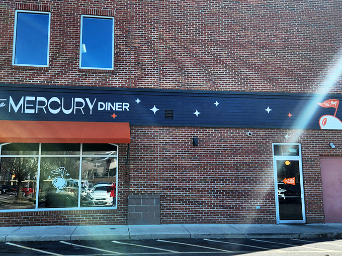 The Mercury Diner's navy blue facade with bright orange awning isn't just inviting&mdash;it's practically a bat signal for hungry Ohioans seeking comfort food nirvana.