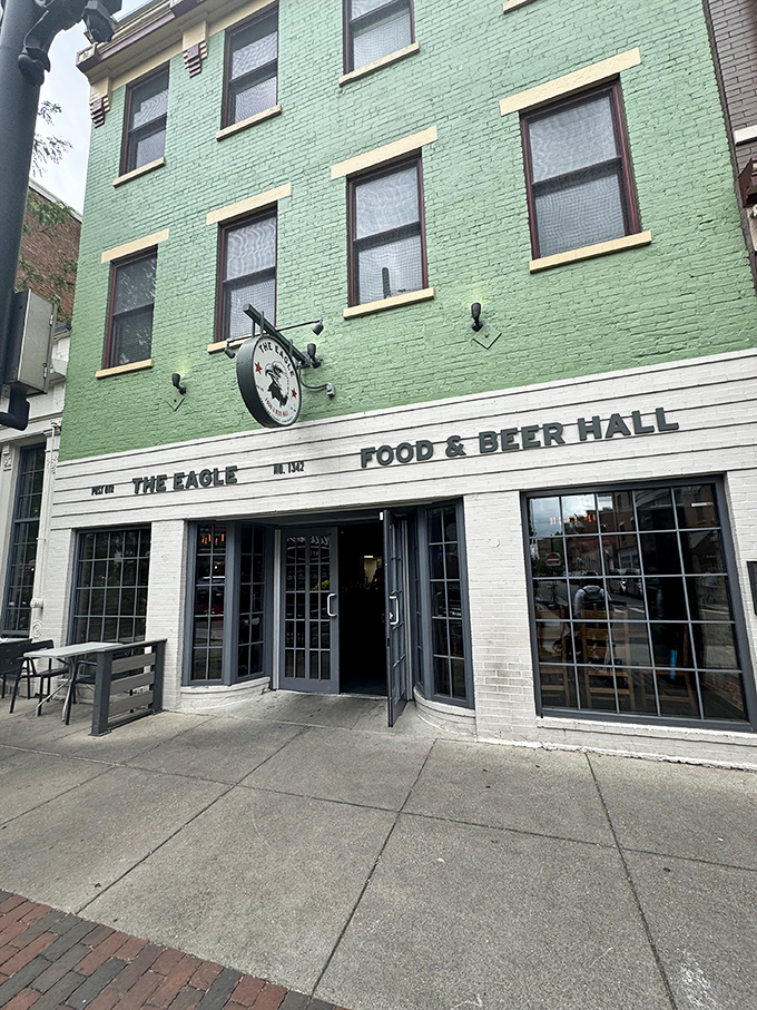 The mint-green facade of The Eagle OTR stands like a beacon of culinary promise in Cincinnati's historic district, its unassuming exterior hiding delicious secrets within.