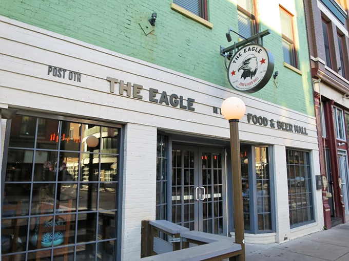 The mint-green facade of The Eagle OTR stands like a beacon of culinary promise in Cincinnati's historic district, its unassuming exterior hiding delicious secrets within.