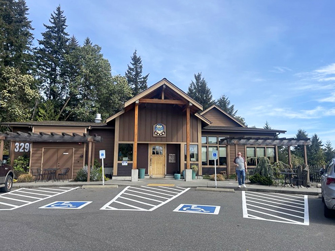 The Oak Table Cafe stands like a woodland retreat among Silverdale's evergreens, promising pancake paradise behind those timber beams.