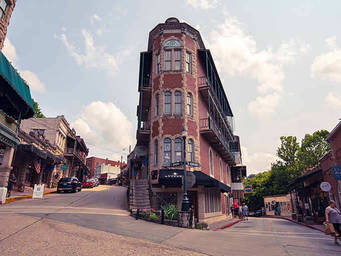 The Flatiron Building of the Ozarks stands proudly at this impossible intersection, defying gravity and common sense with Victorian flair.