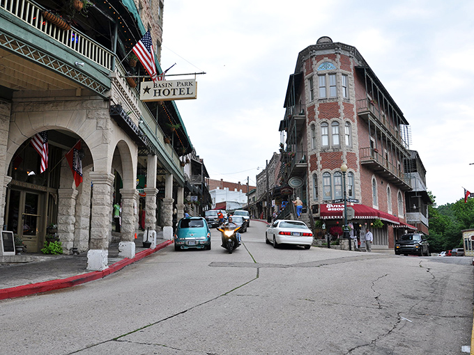 Downtown Eureka Springs curves like a Victorian dream, where red brick buildings and historic hotels create a postcard-perfect scene that defies modern architectural monotony.