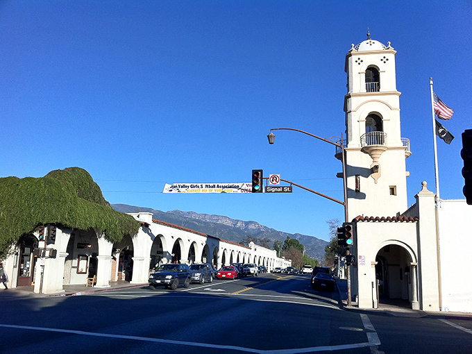 Downtown Ojai welcomes visitors with its iconic bell tower and Spanish Colonial architecture, framed by the majestic Topatopa Mountains that create the valley's famous "pink moment" at sunset.