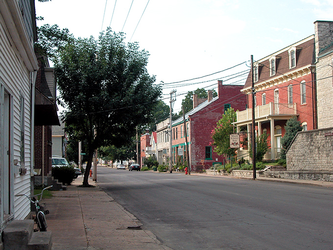 The historic Hotel Ste. Genevieve stands as a red brick sentinel to the past, welcoming visitors with its wraparound porch and promise of stories within.