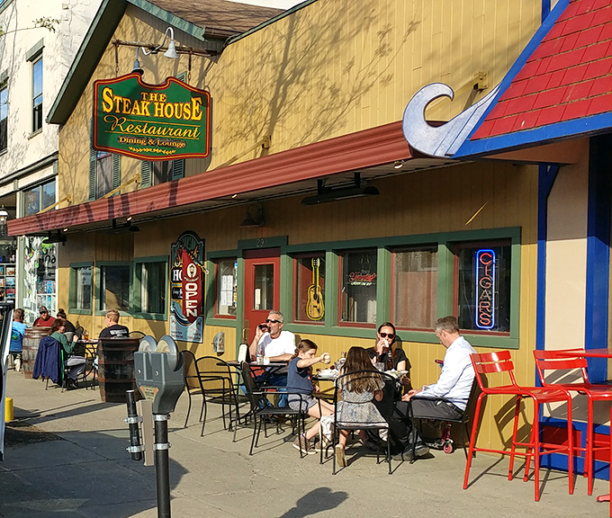 The charming yellow exterior of The Steak House stands proudly on Wellsboro's tree-lined main street, a beacon for hungry travelers seeking carnivorous bliss.
