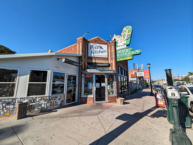 That iconic neon sign beckons like an old friend, promising comfort food and conversations that matter on Denver's storied Colfax Avenue.