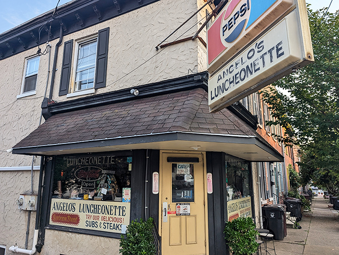 The iconic Pepsi sign beckons hungry travelers to Angelo's Luncheonette, a Wilmington institution where time stands deliciously still since 1967.