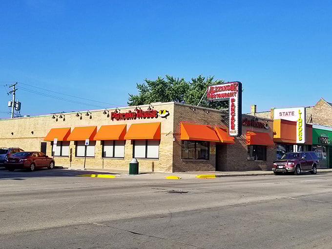 The iconic red awning of Alexander's stands out like a breakfast lighthouse, beckoning hungry travelers with its promise of pancake perfection.