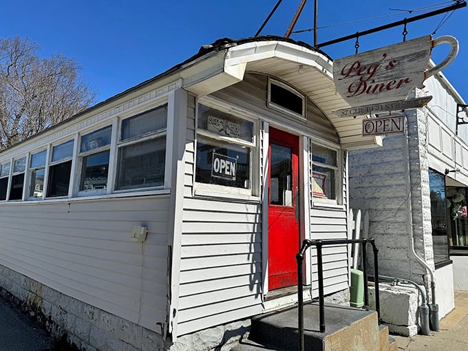 The unassuming white exterior with that pop of red door is like finding a treasure map in your attic&mdash;modest packaging, extraordinary reward inside.