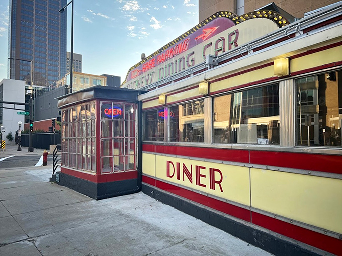 Mickey's iconic red and cream exterior stands like a time capsule on St. Paul's street corner, beckoning hungry travelers with its neon promise of comfort food.