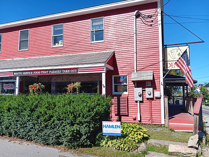 The cherry-red exterior of Four Aces Diner stands out like a winning hand in West Lebanon, beckoning hungry travelers with its classic Americana charm.